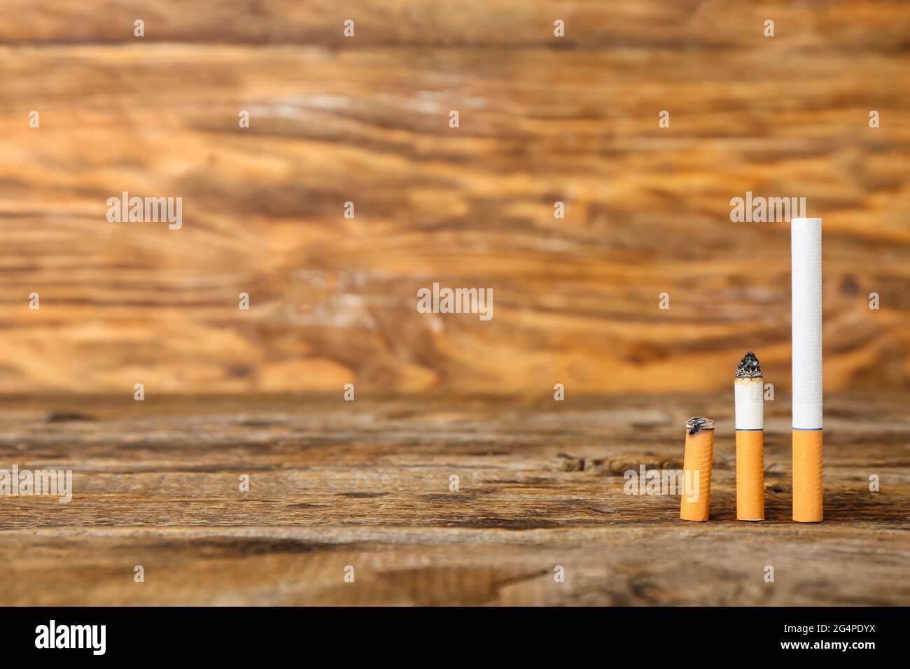 Different cigarettes on wooden background Stock Photo - Alamy
