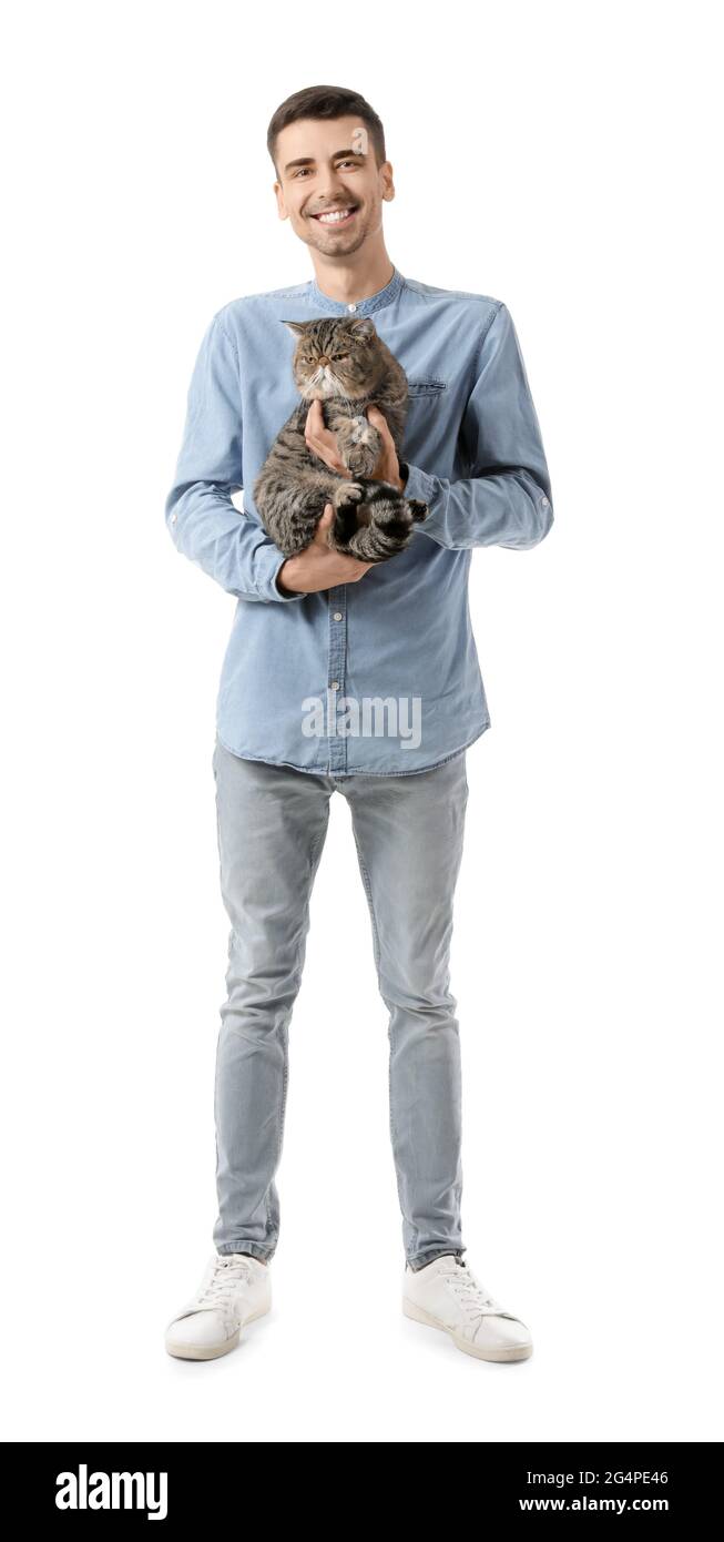 Young man with cute cat on white background Stock Photo - Alamy