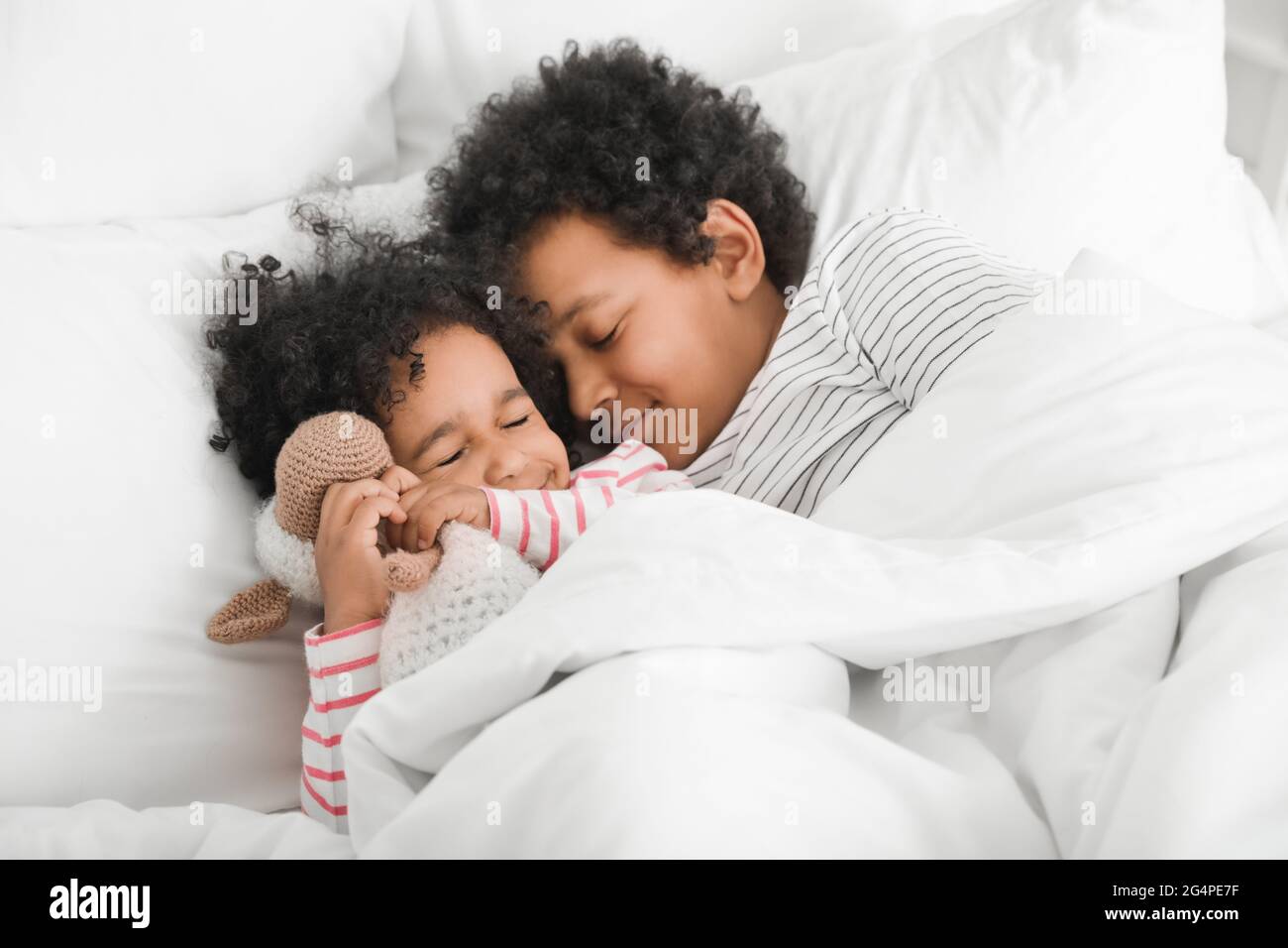 African-American children lying in bed Stock Photo - Alamy