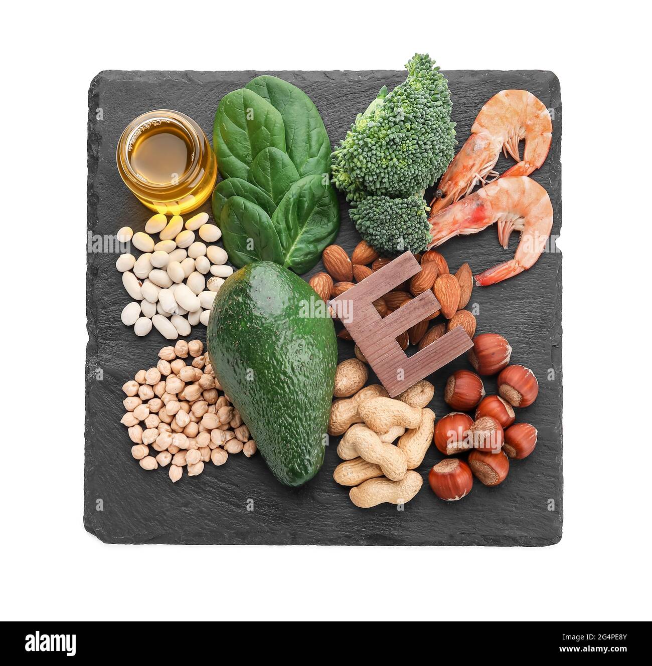 Slate plate with healthy products rich in vitamin E on white background ...