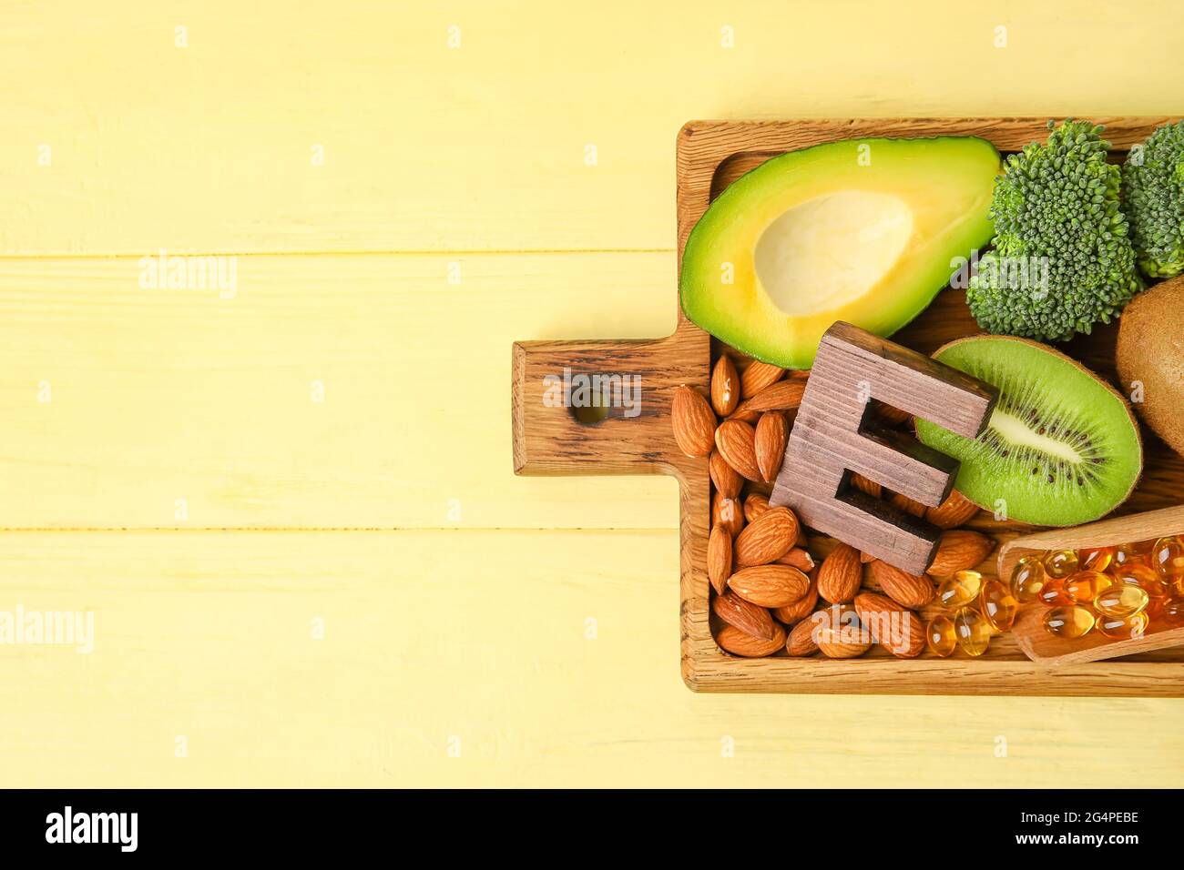 Board with healthy products rich in vitamin E on color wooden ...