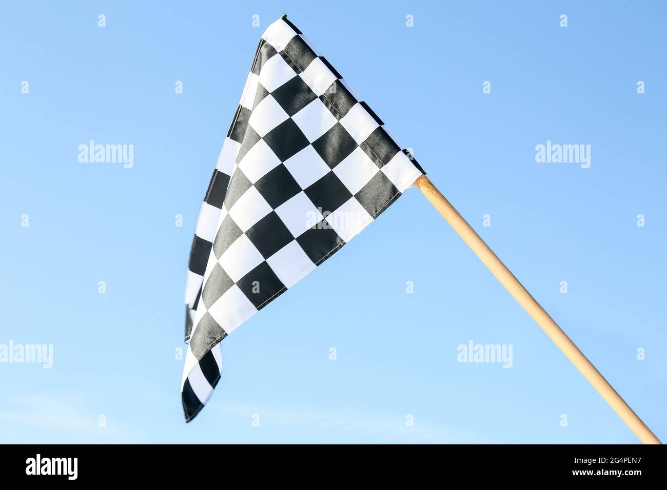 Racing flag against blue sky Stock Photo - Alamy