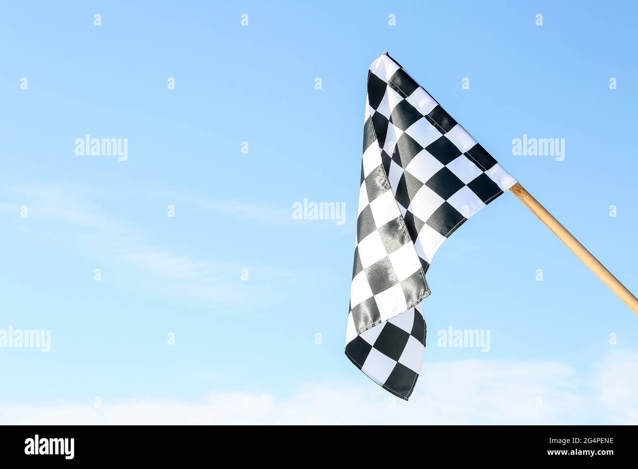 Racing flag against blue sky Stock Photo - Alamy