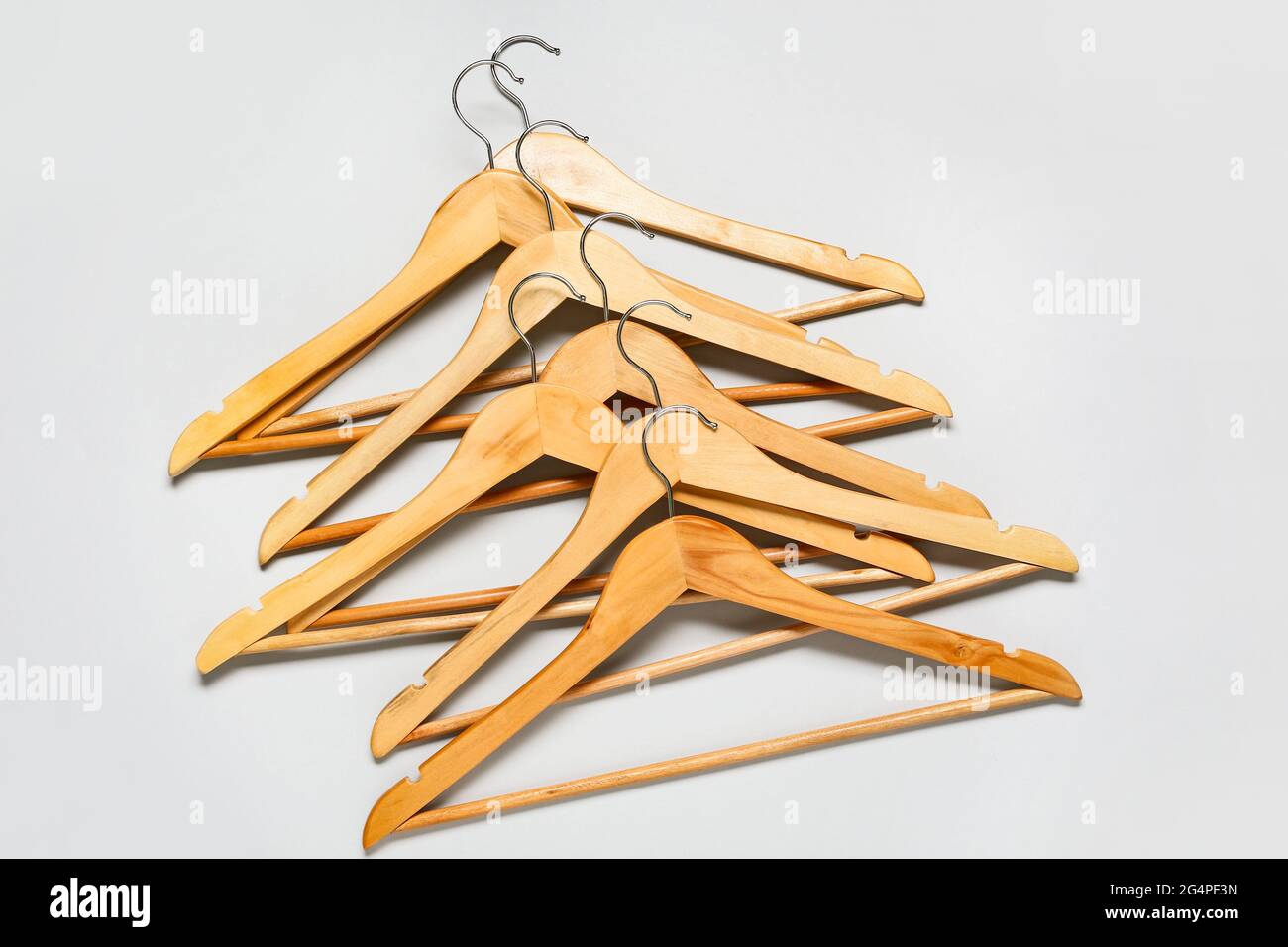 Stylish clothes hangers on light background Stock Photo - Alamy