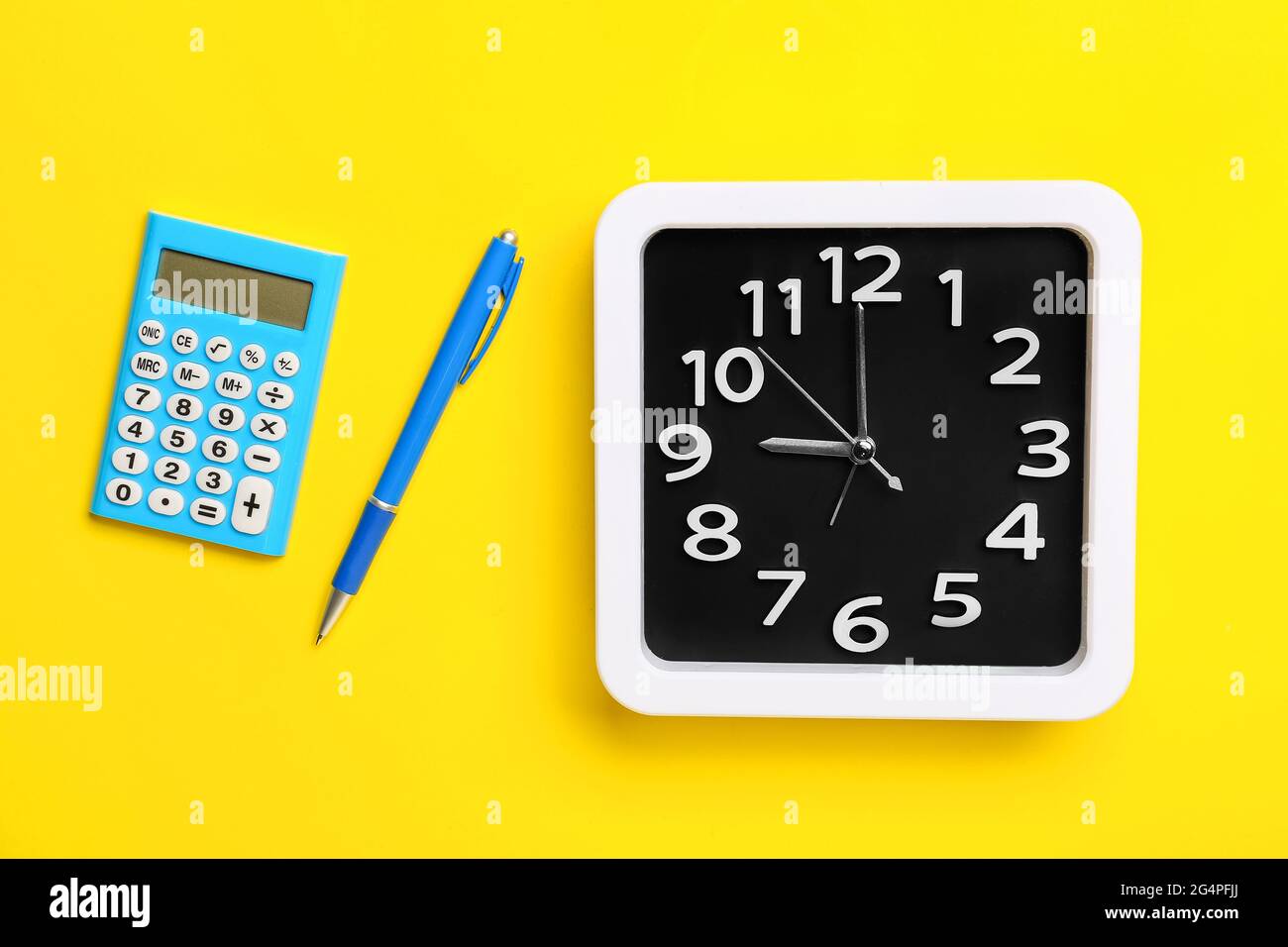 Stylish clock with pen and calculator on color background Stock Photo ...
