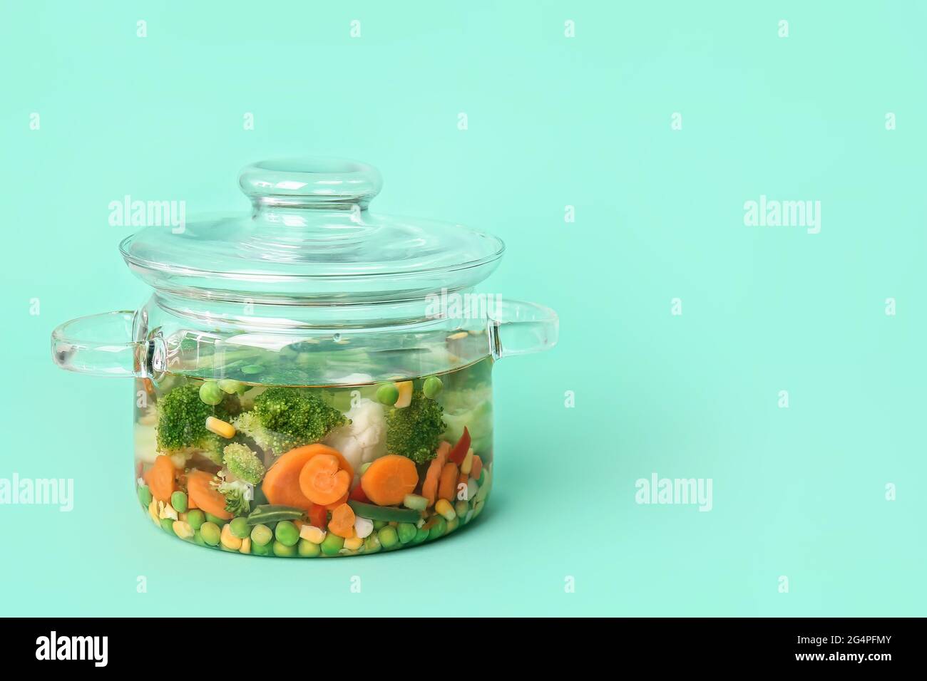Stylish cooking pot with tasty soup on color background Stock Photo - Alamy