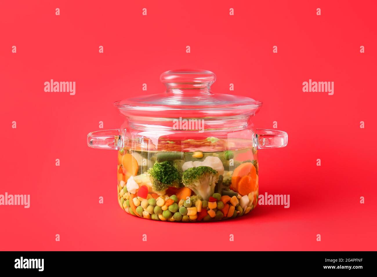Stylish cooking pot with tasty soup on color background Stock Photo - Alamy