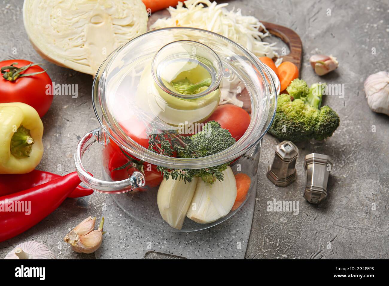 Stylish cooking pot with fresh vegetables on grunge background Stock ...