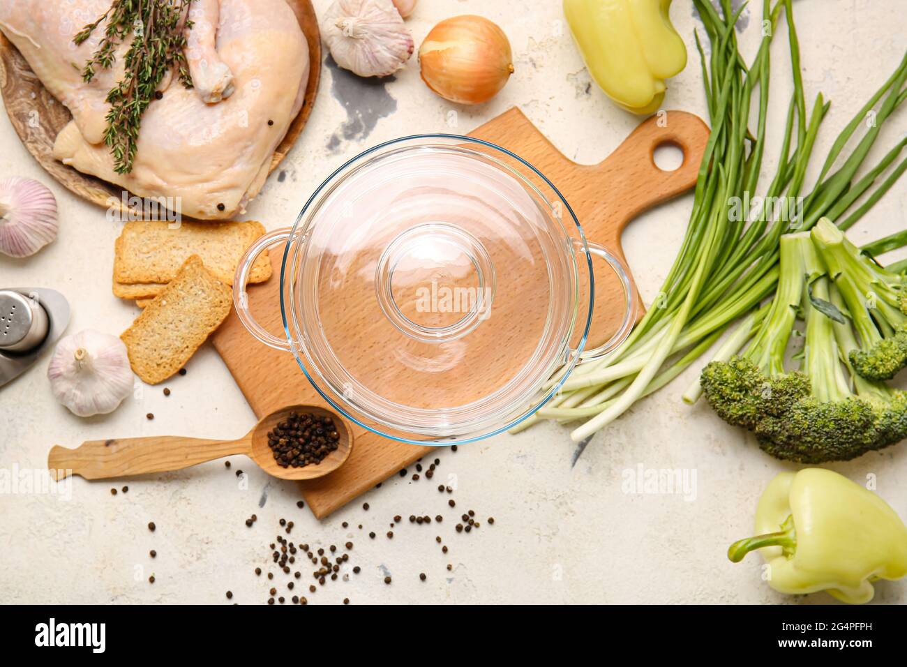 Stylish cooking pot and fresh ingredients on light background Stock ...