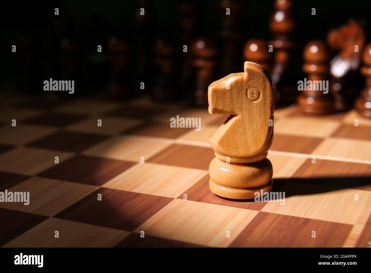 Chess board with knight on dark background Stock Photo - Alamy