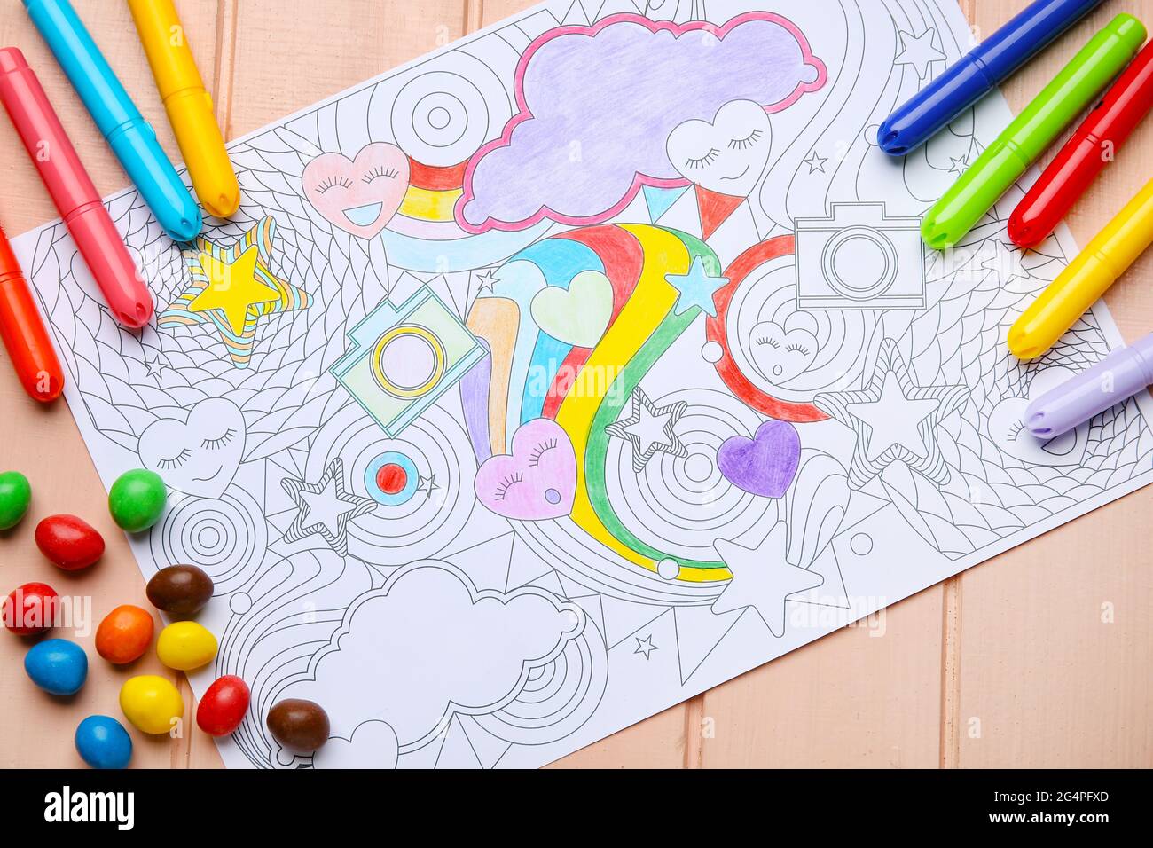 Composition with coloring picture on color wooden table Stock Photo - Alamy