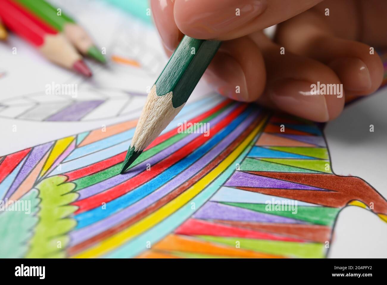 Woman coloring picture at table, closeup Stock Photo - Alamy