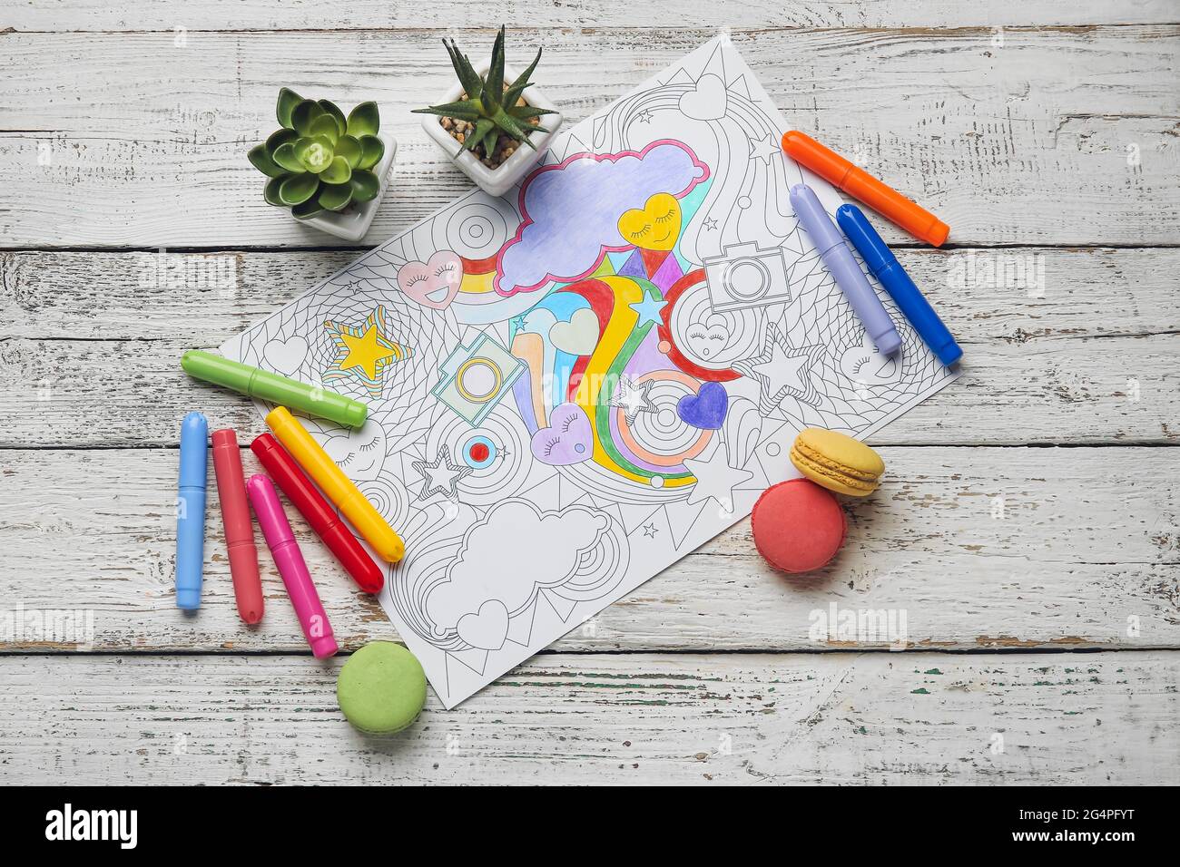 Composition with coloring picture on light wooden table Stock Photo - Alamy