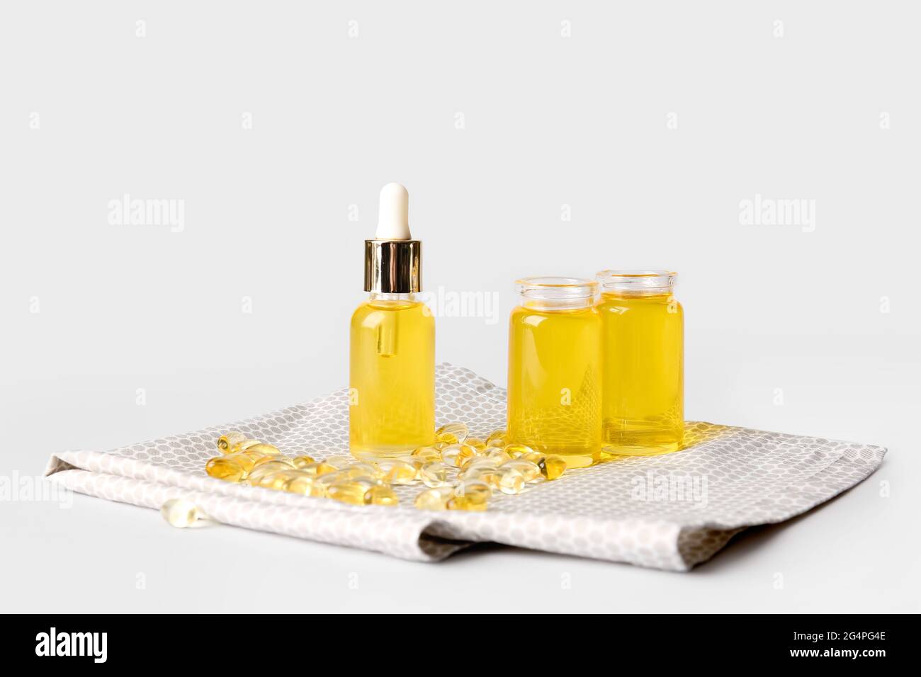 Bottles of fish oil and capsules on light background Stock Photo - Alamy