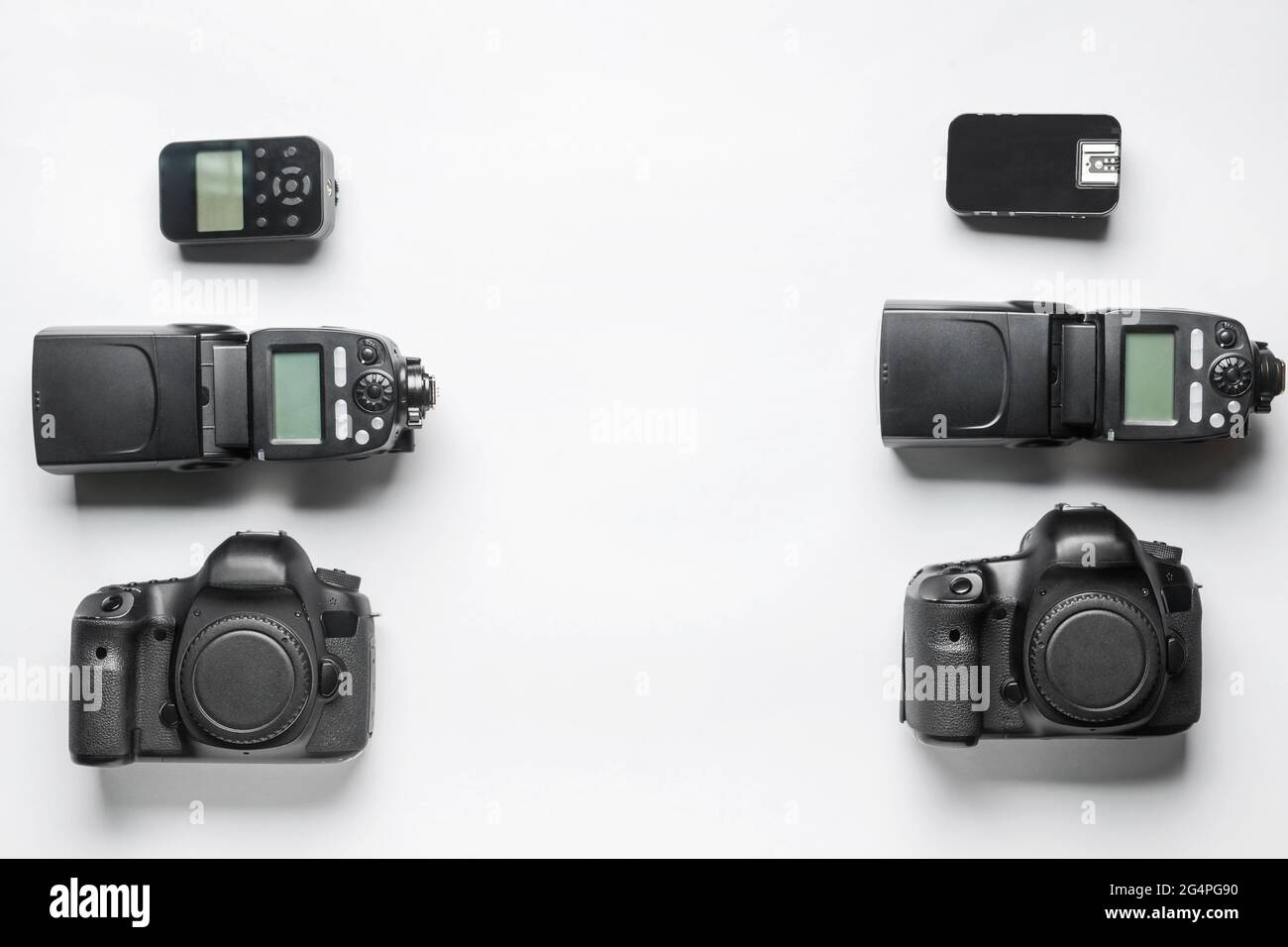 Digital cameras and wireless flash trigger on light background Stock ...