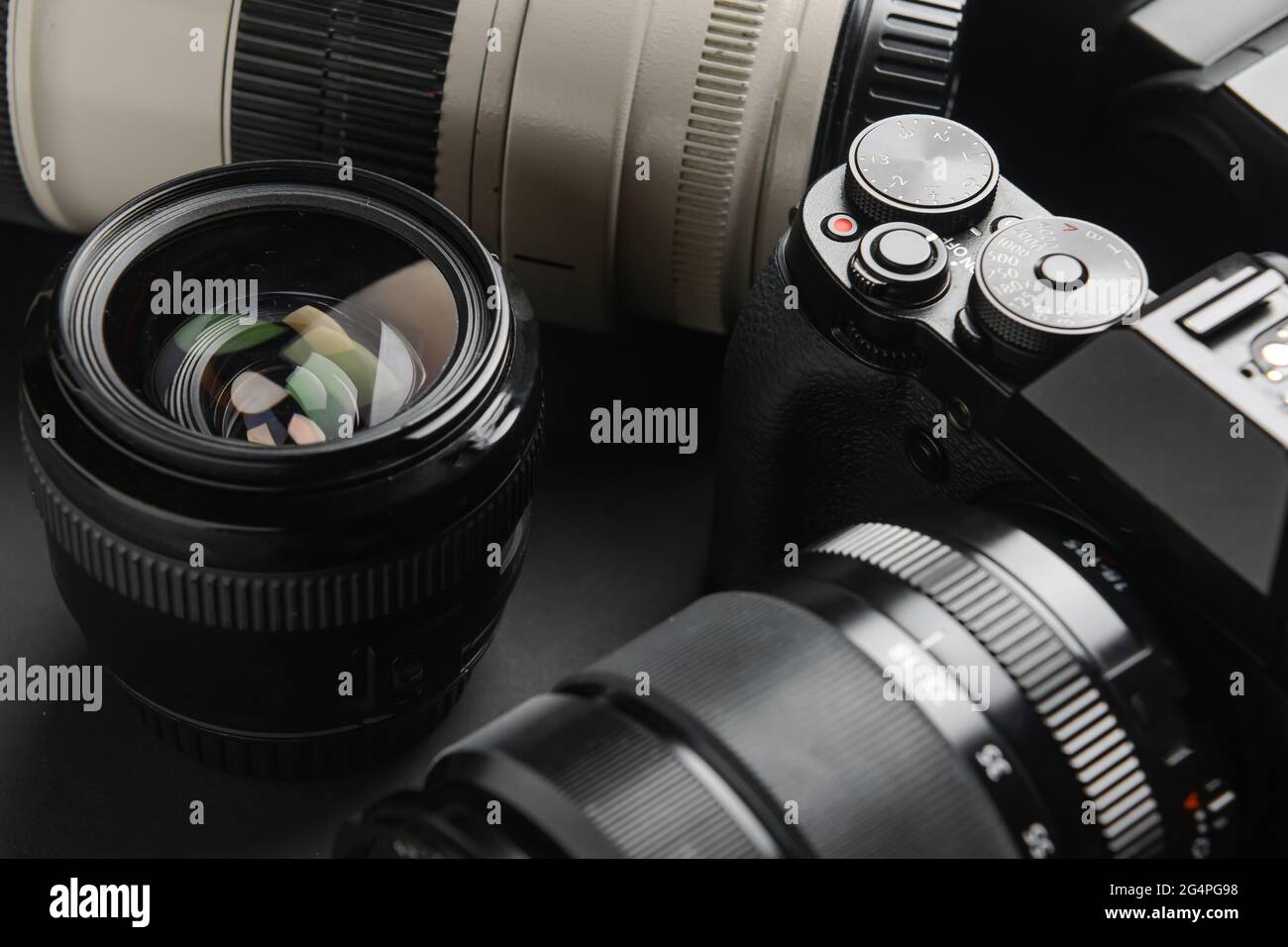Digital camera and lenses on dark background, closeup Stock Photo - Alamy
