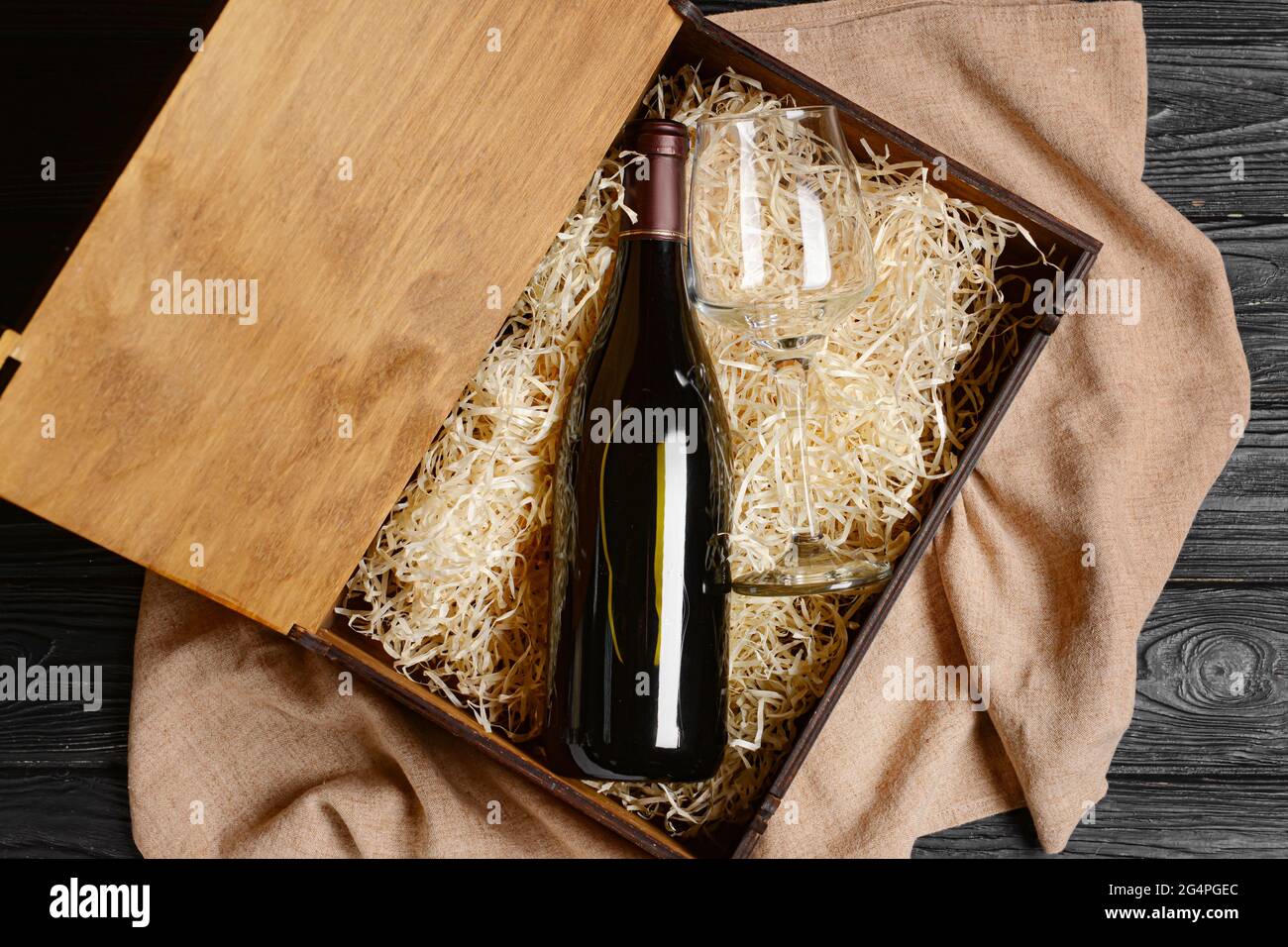Box with bottle of wine and glass on dark wooden background Stock Photo ...