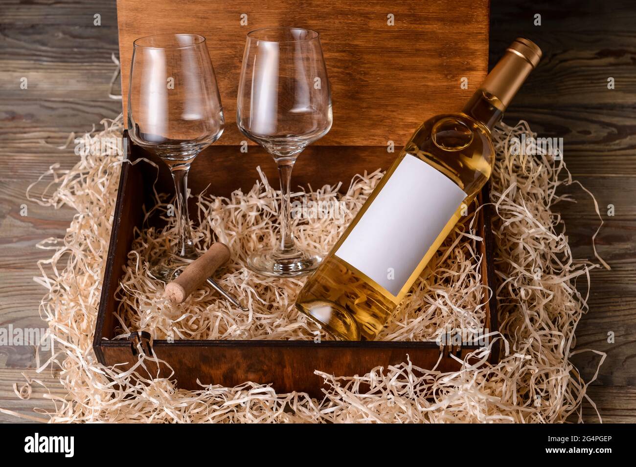 Box with bottle of wine and glasses on wooden background Stock Photo ...
