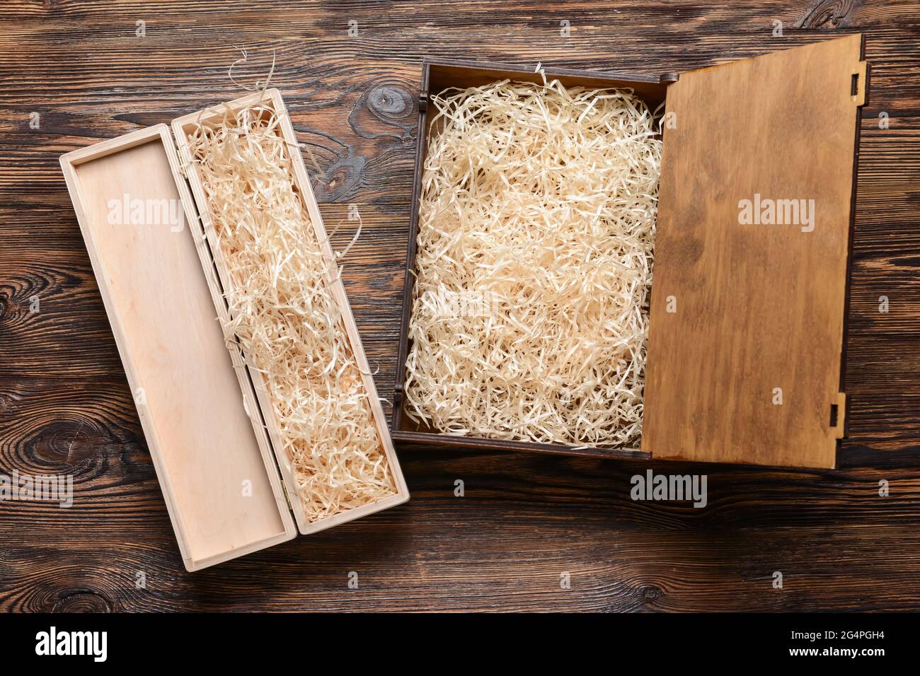 Open wine boxes on wooden background Stock Photo - Alamy
