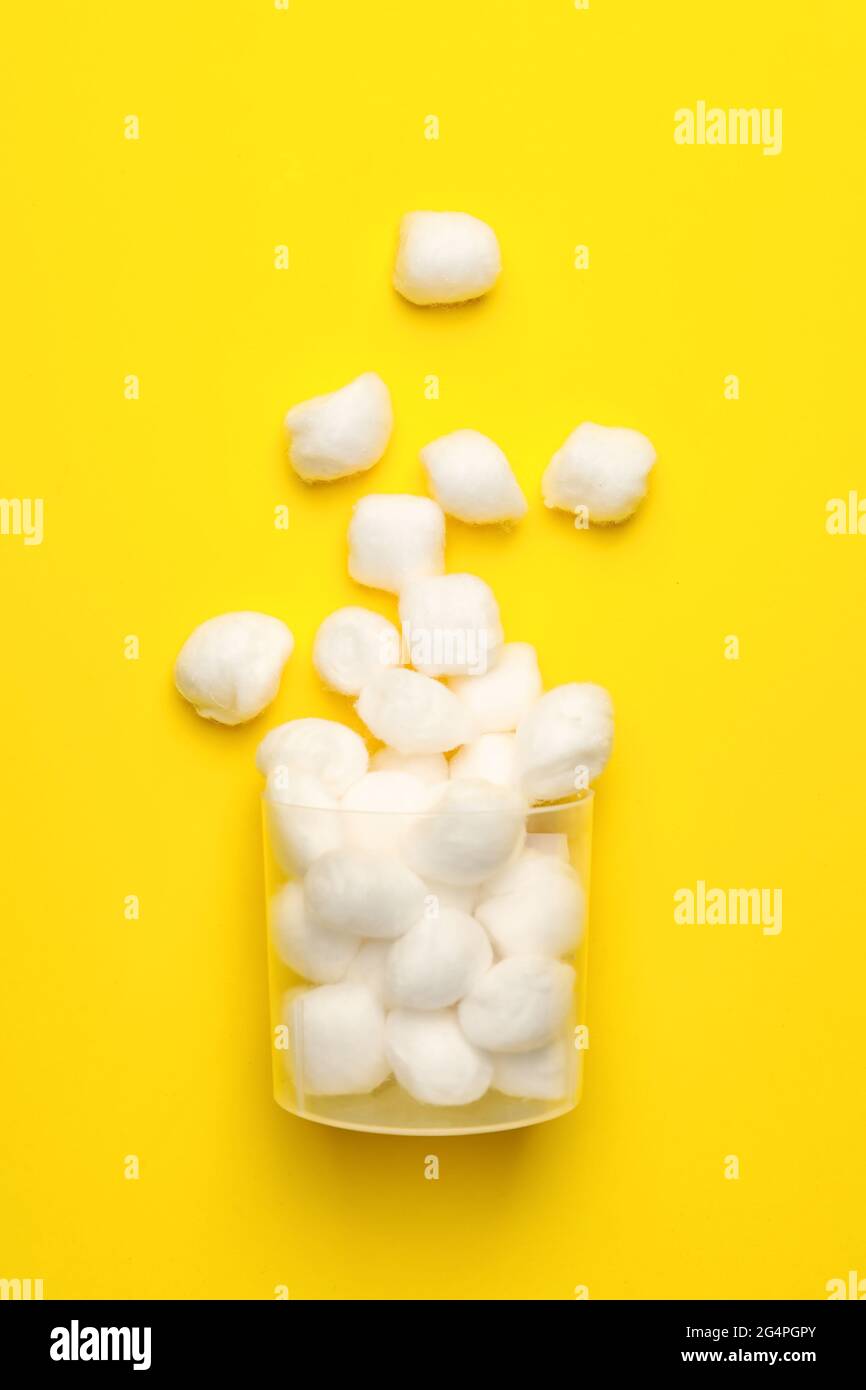 Container with cotton wool on color background Stock Photo - Alamy