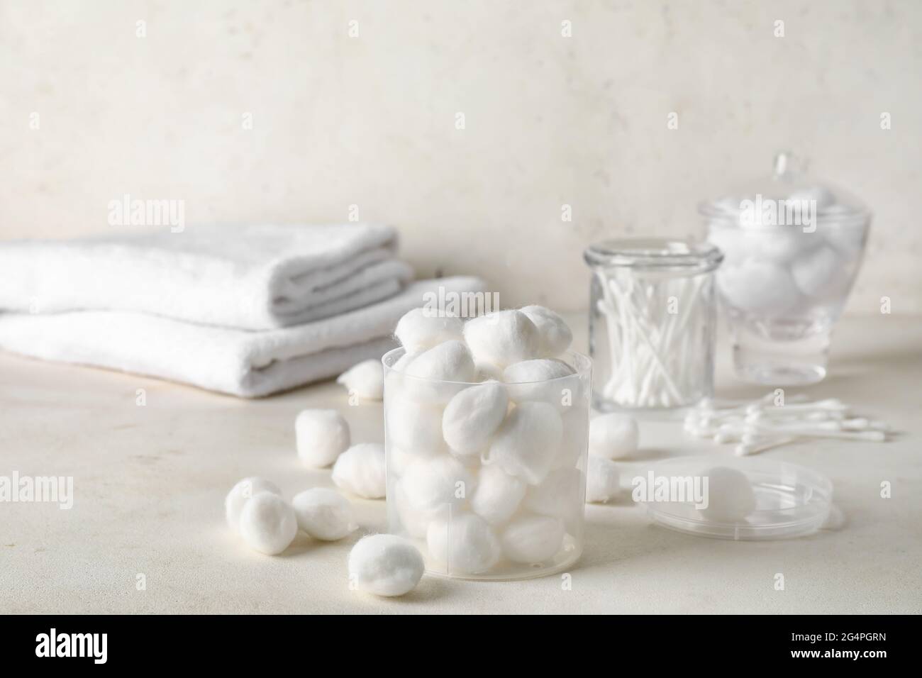 Container with soft cotton wool on light background Stock Photo - Alamy