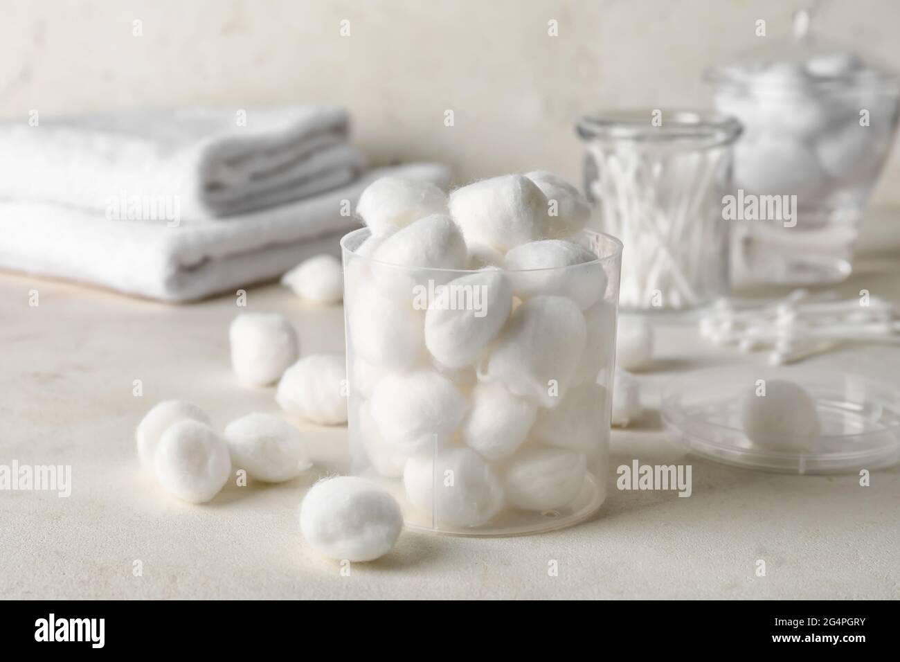 Container with soft cotton wool on light background Stock Photo - Alamy