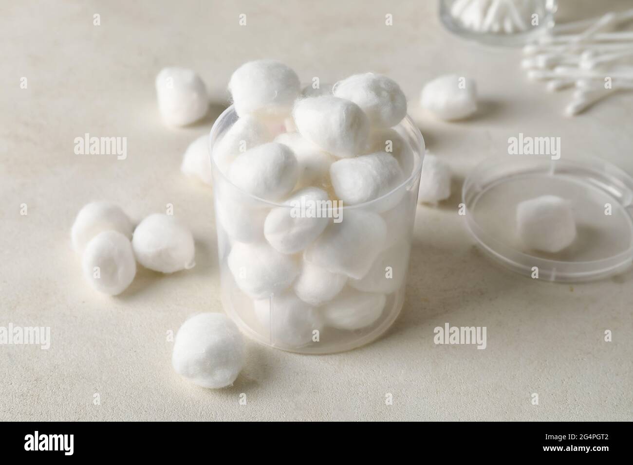 Container with soft cotton wool on light background Stock Photo - Alamy