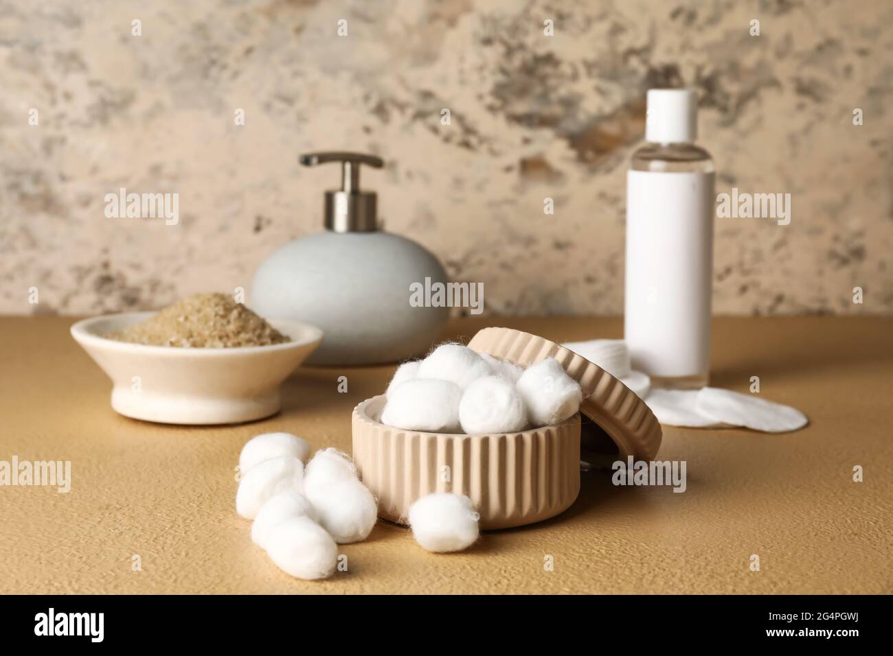 Container with soft cotton wool on table in bathroom Stock Photo - Alamy