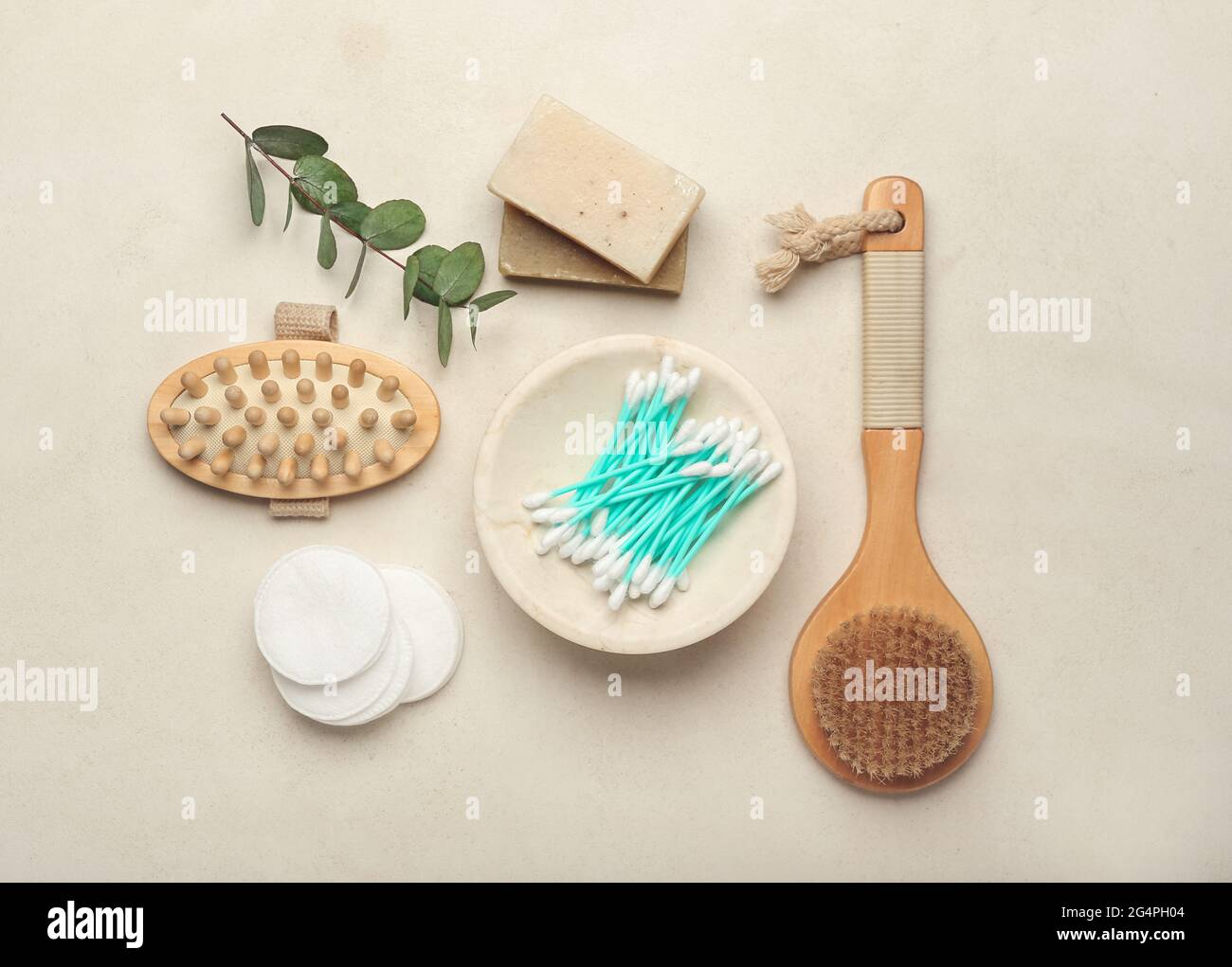 Composition with cotton swabs, comb, brush, soap and buds on light ...
