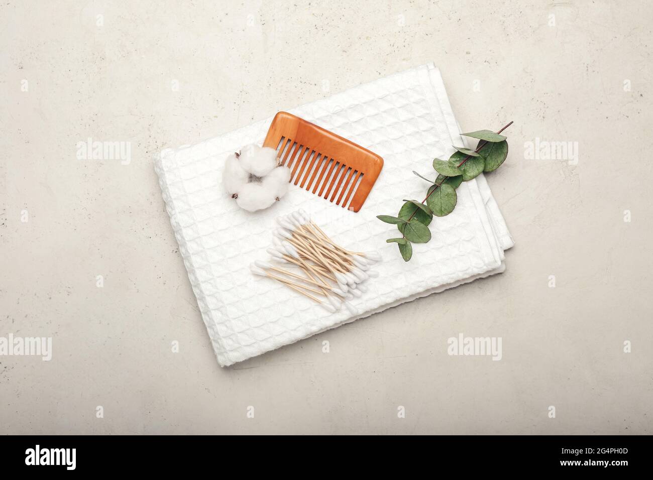 Cotton swabs, flower and comb on light background Stock Photo - Alamy