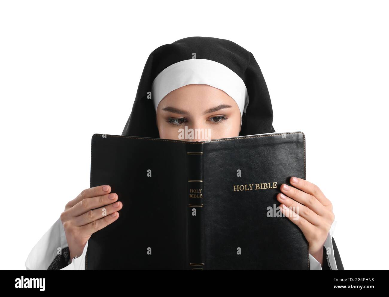 Young nun with Bible on white background Stock Photo - Alamy