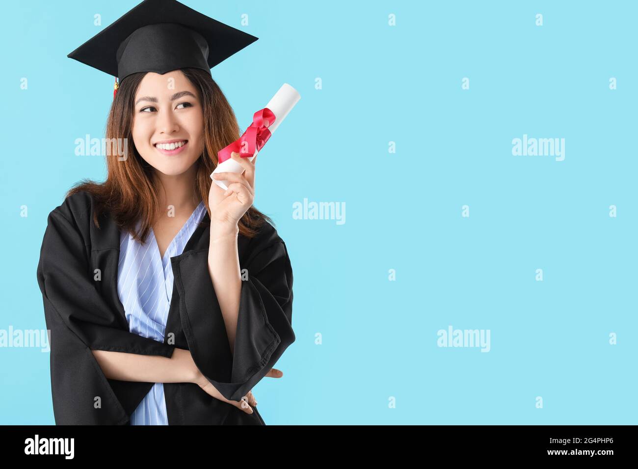 Female graduating student with diploma on color background Stock Photo ...