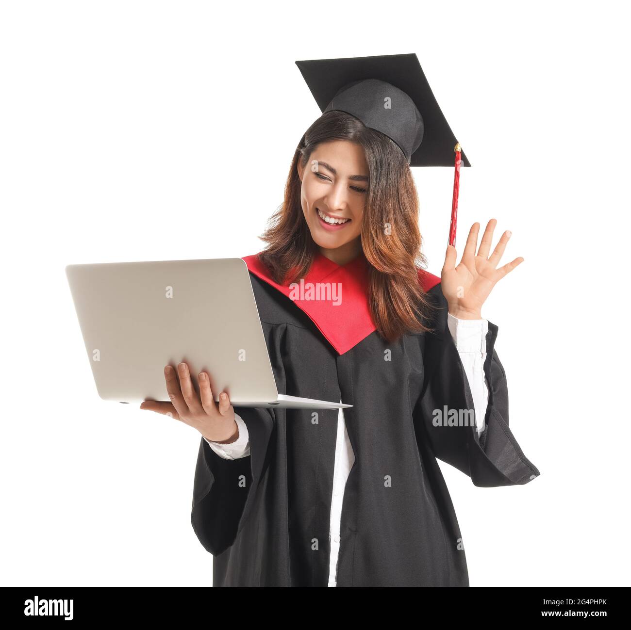 Female graduating student with laptop on white background Stock Photo ...