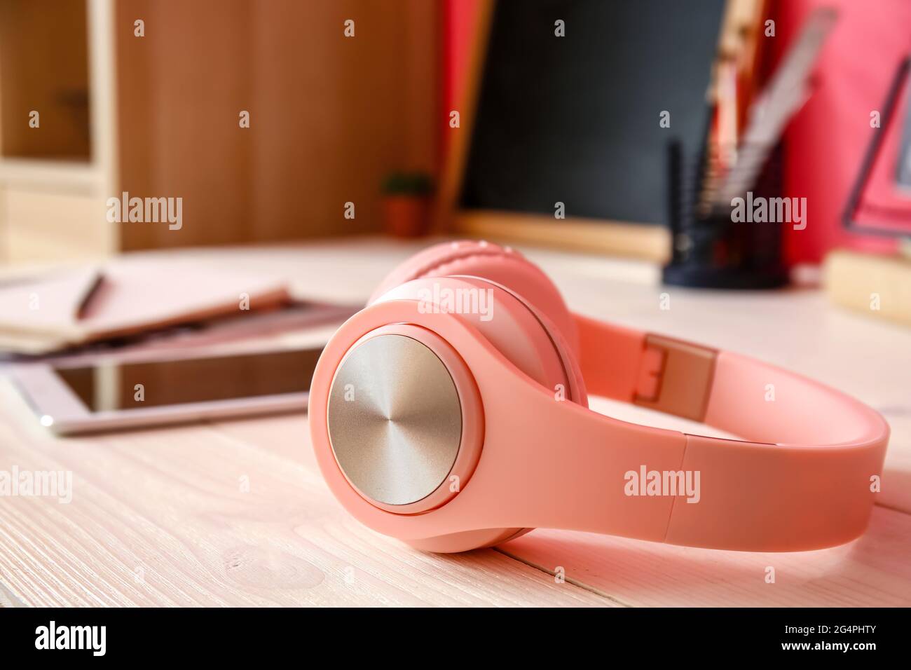 Modern headphones on table in room Stock Photo - Alamy