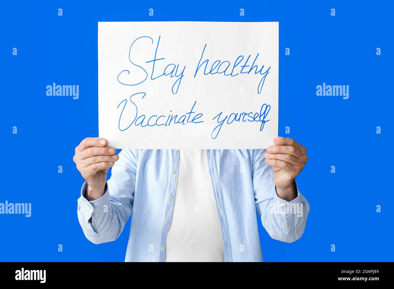 Senior man holding poster with text STAY HEALTHY - VACCINATE YOURSELF ...
