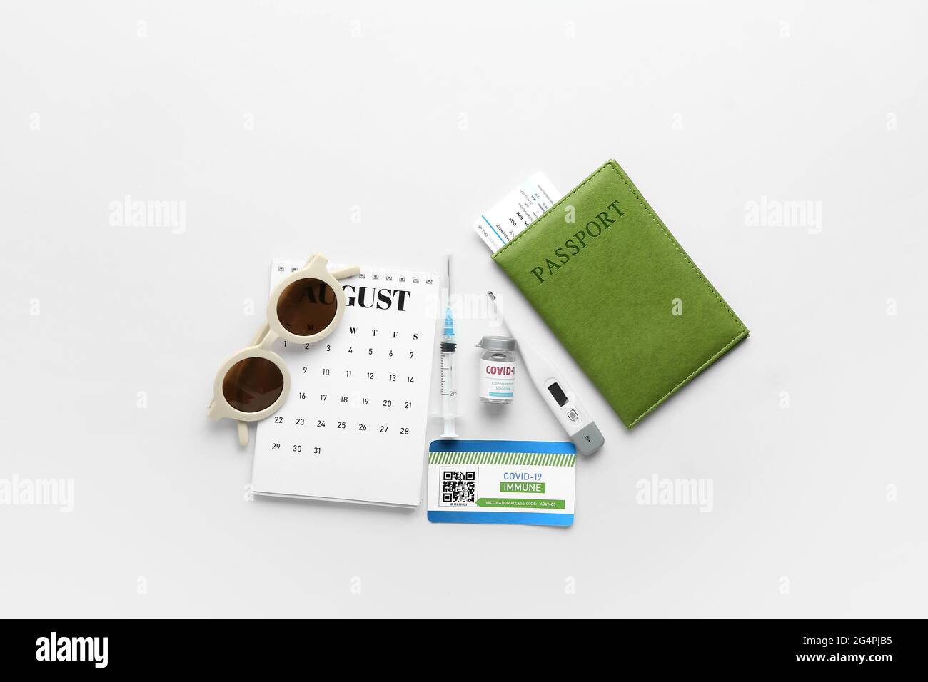 Passport, ticket, covid-19 vaccine, immune card and calendar on white ...