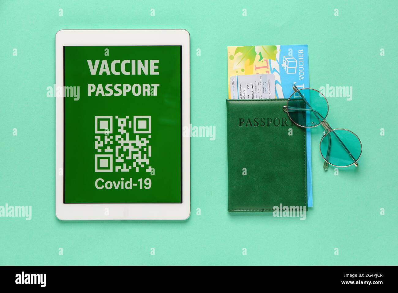Electronic immune passport on screen of tablet computer, ticket and ...
