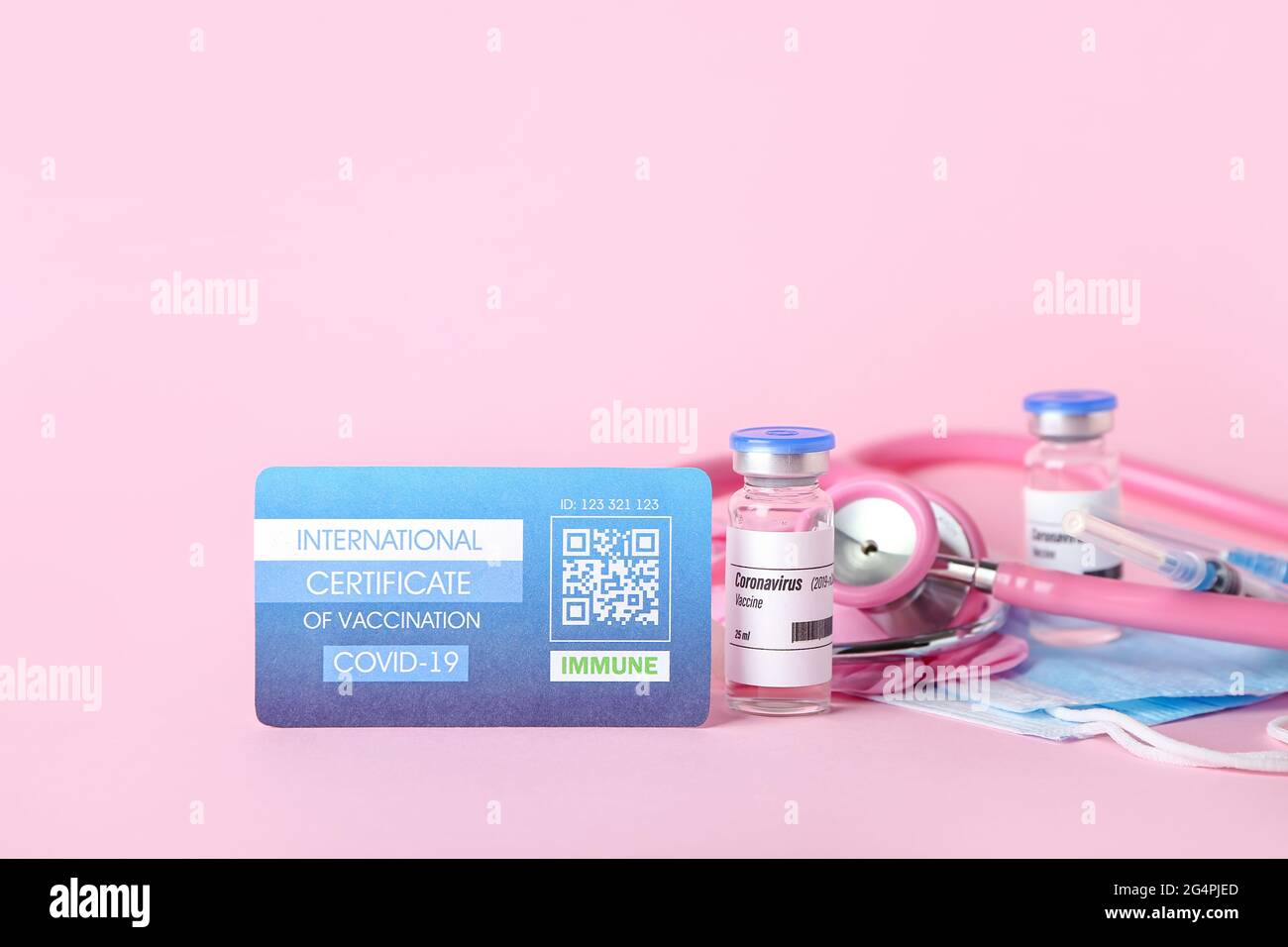 Immune card, medical masks and stethoscope with covid-19 vaccine on ...