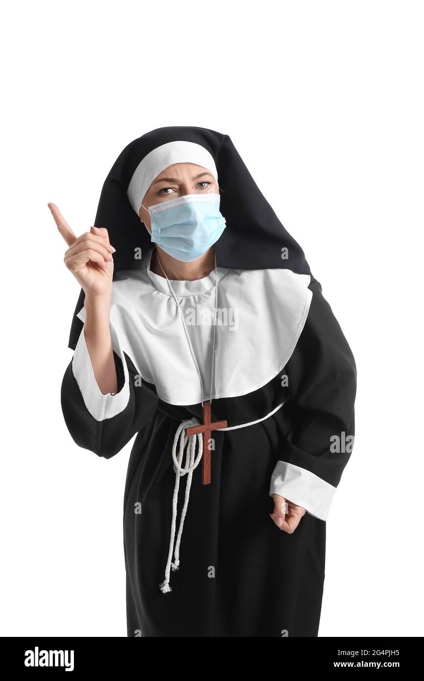 Severe mature nun in medical mask on white background Stock Photo - Alamy