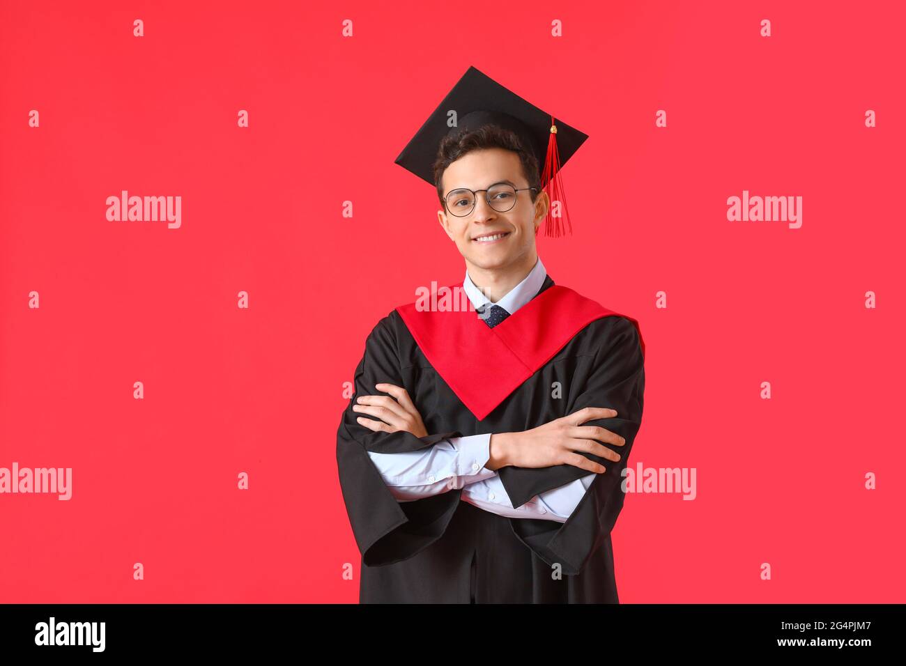 Male graduating student on color background Stock Photo - Alamy