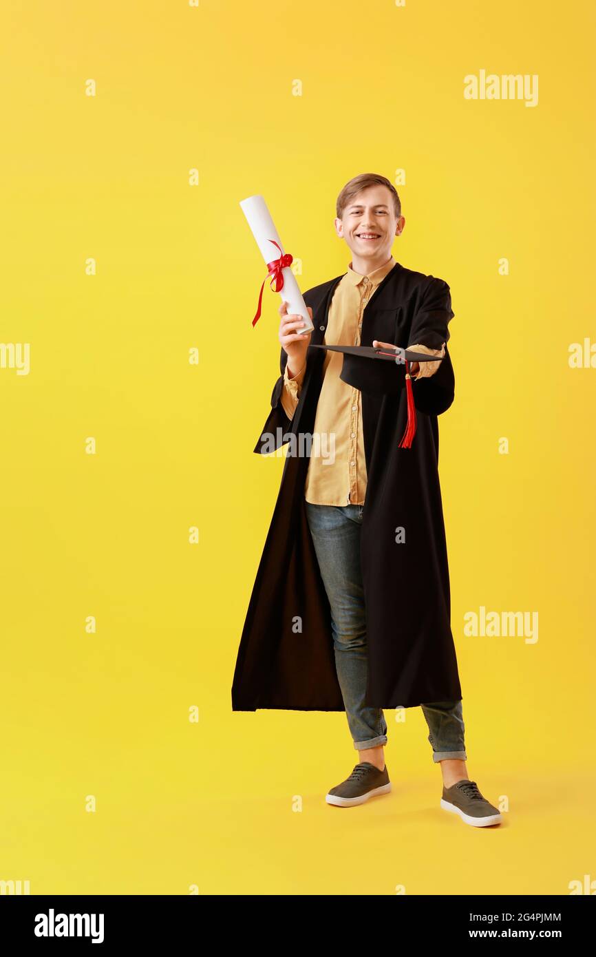 Male graduating student on color background Stock Photo - Alamy