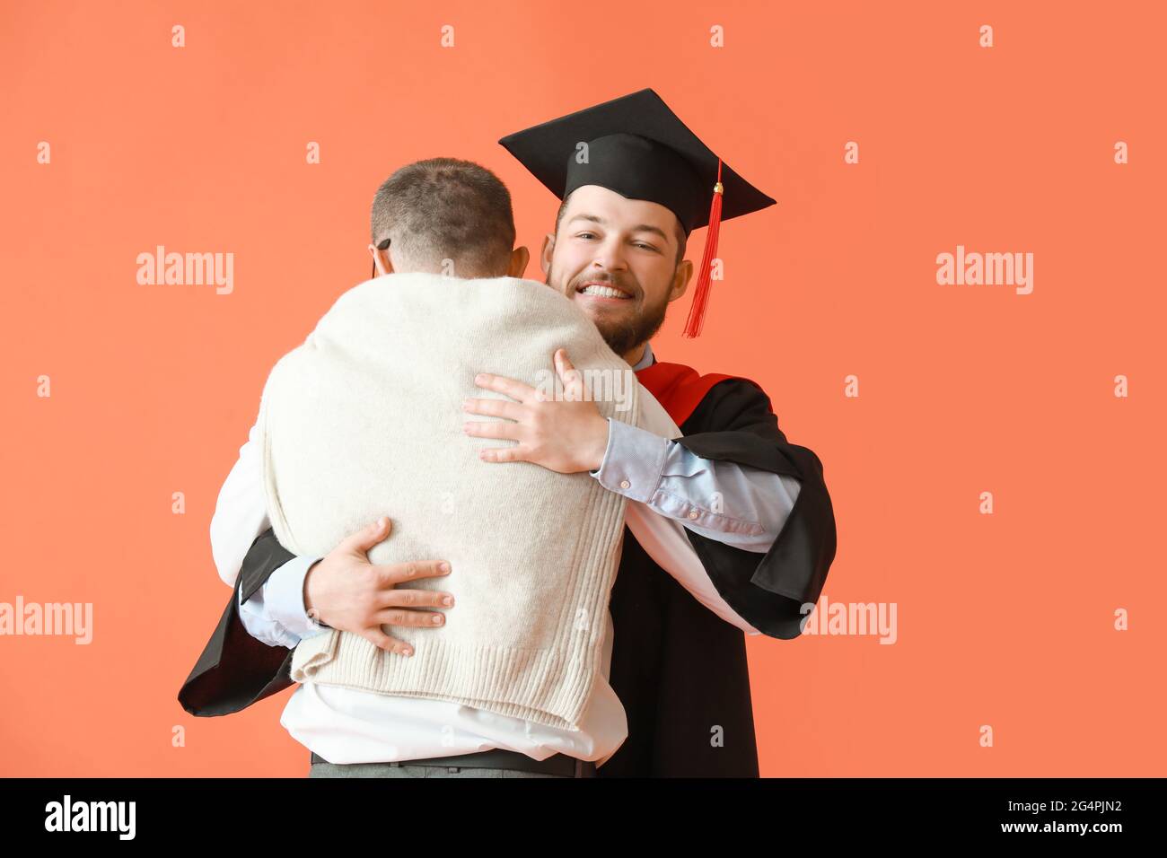Father hugging son at graduation hi-res stock photography and images ...