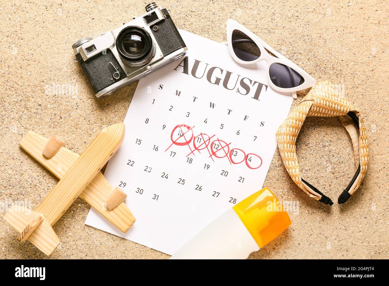 Calendar with marked dates and beach accessories on sand Stock Photo ...