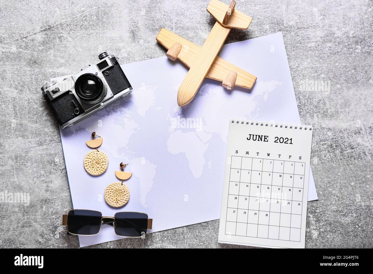 Calendar, world map and travel accessories on grunge background Stock ...