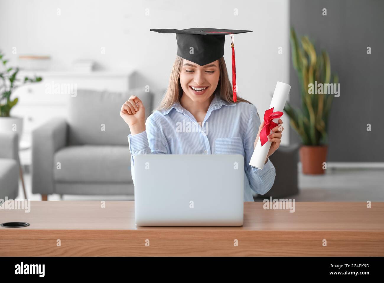 Happy female student on her graduation day at home. Concept of studying ...