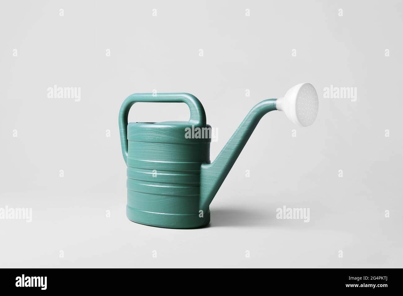 Watering can on white background Stock Photo - Alamy