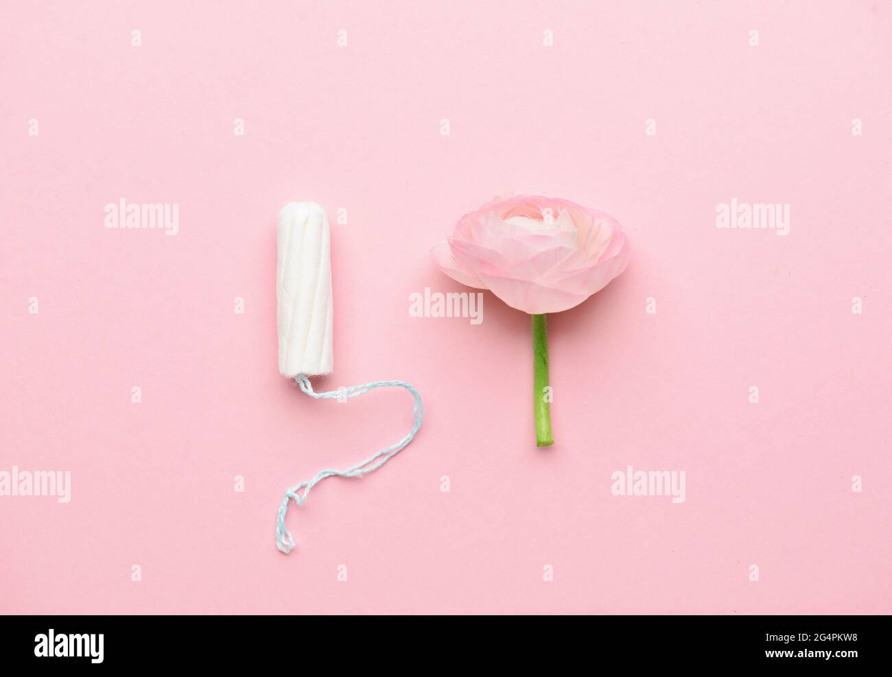 Tampon and flower on color background Stock Photo - Alamy