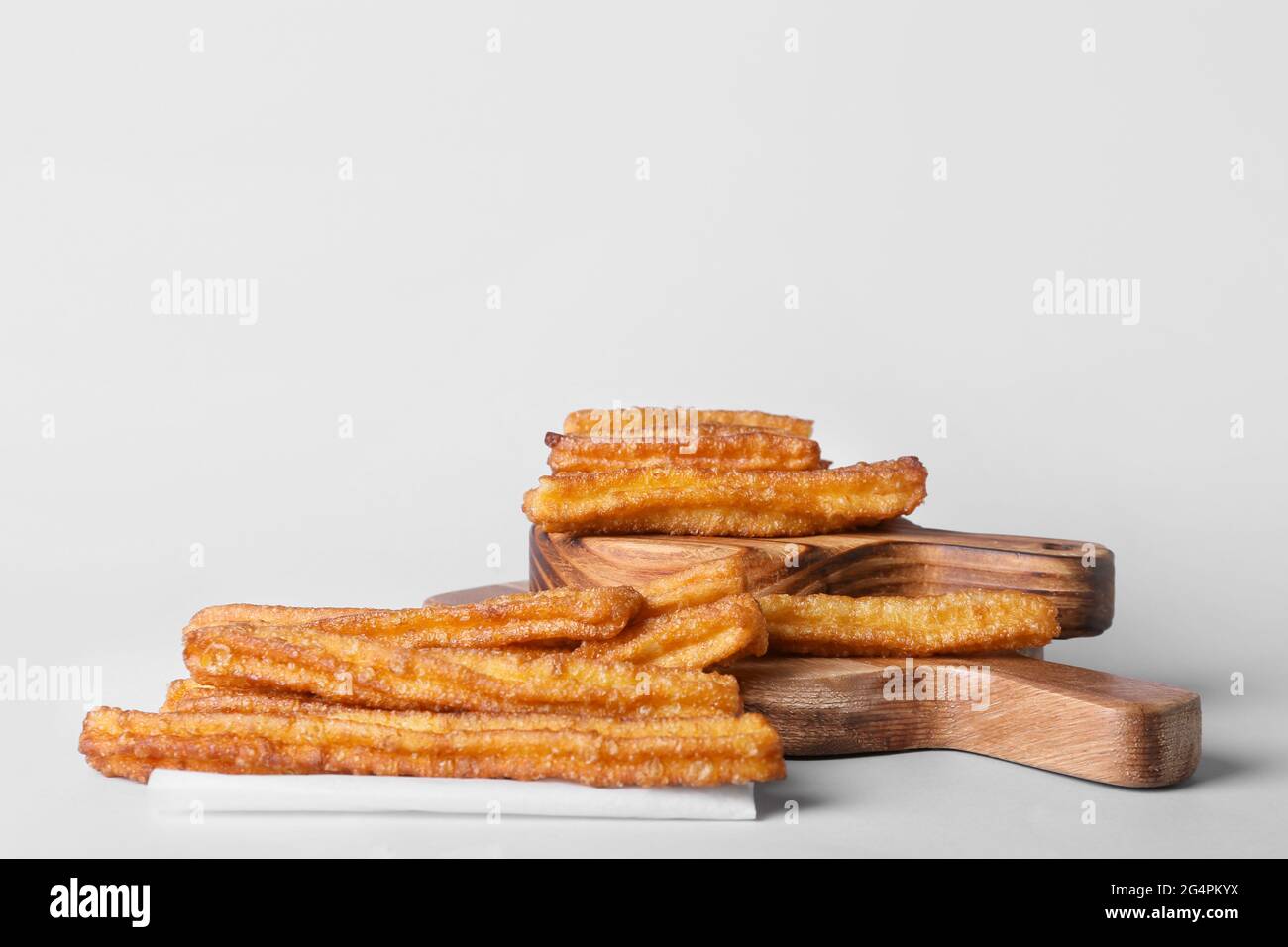 Boards with tasty churros on white background Stock Photo - Alamy