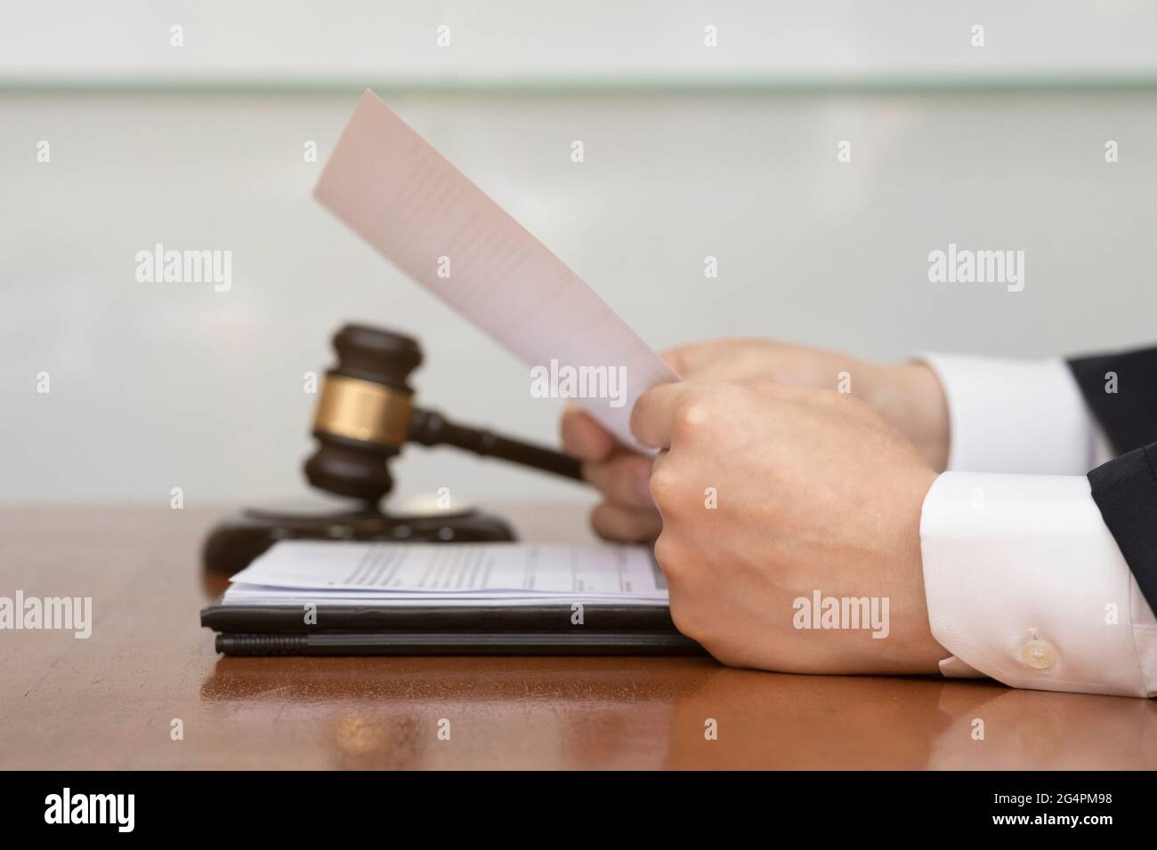 hand of judge, gavel and papers Stock Photo - Alamy