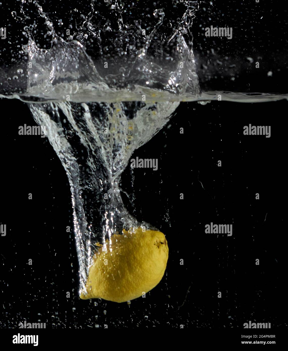Fresh Lemon Dropped Into Water With Splash Isolated On black background ...